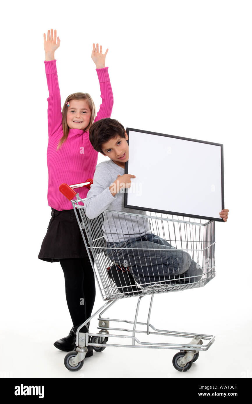 Two kids with trolley Stock Photo - Alamy