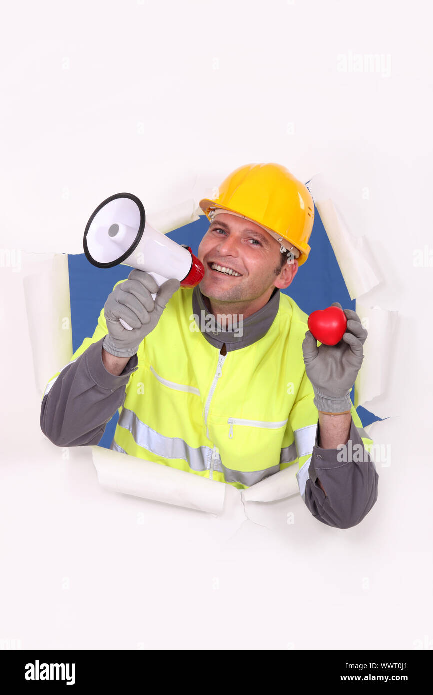 Construction worker proclaiming his love Stock Photo - Alamy