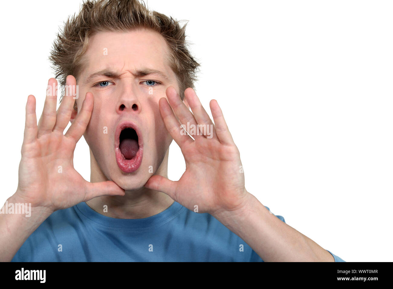 Young man shouting Stock Photo - Alamy