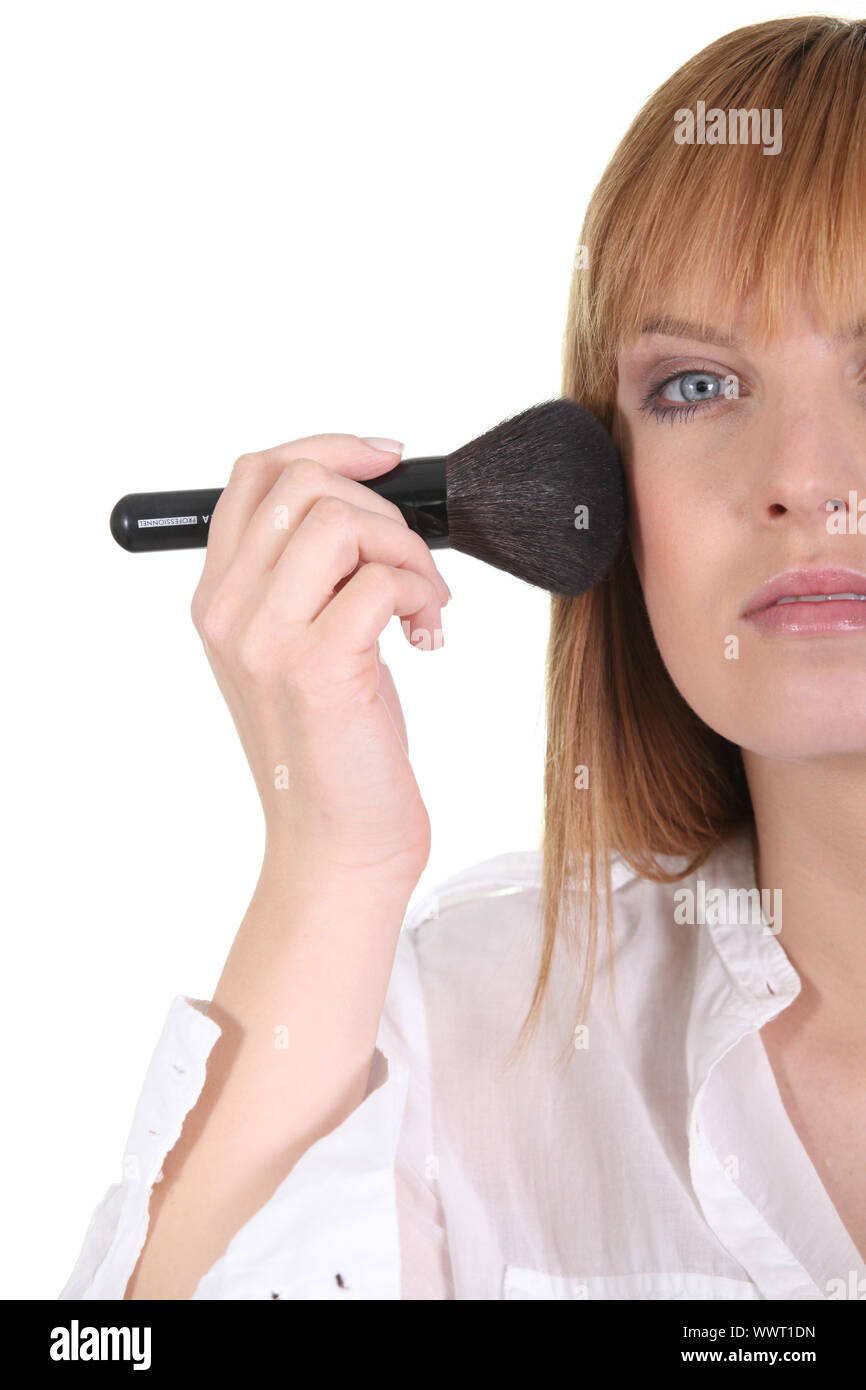 Woman applying blush Stock Photo - Alamy