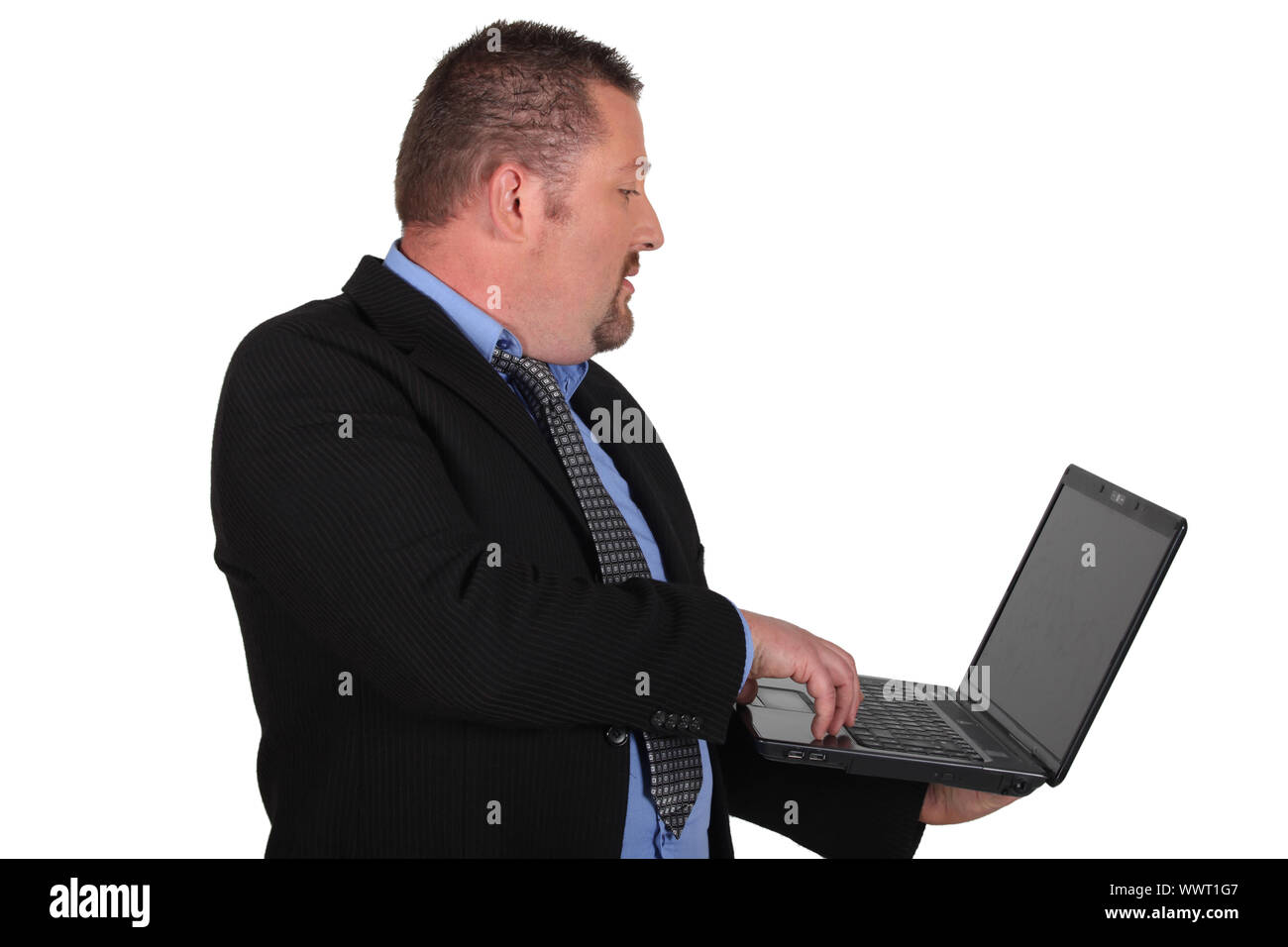 Man in suit holding laptop computer, studio shot Stock Photo - Alamy