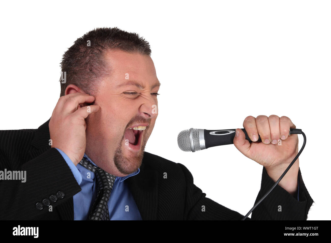 Man singing with microphone Stock Photo - Alamy