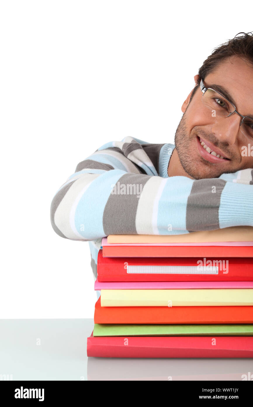 Smiling man with a stack of files Stock Photo - Alamy