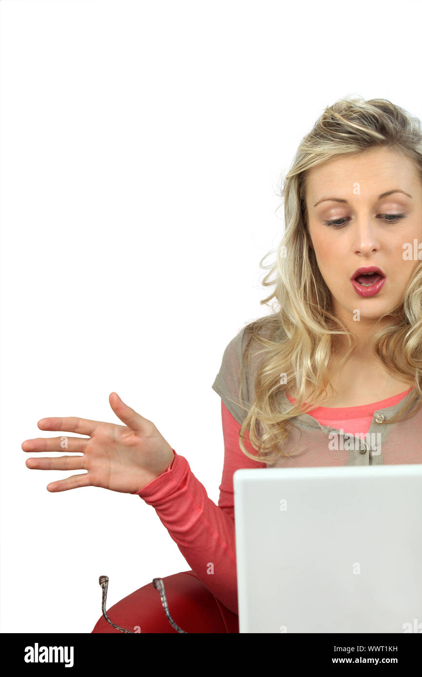 Girl with expression of surprise using laptop computer Stock Photo - Alamy