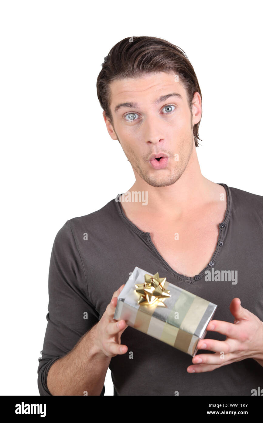 a man receiving a gift is surprised Stock Photo - Alamy