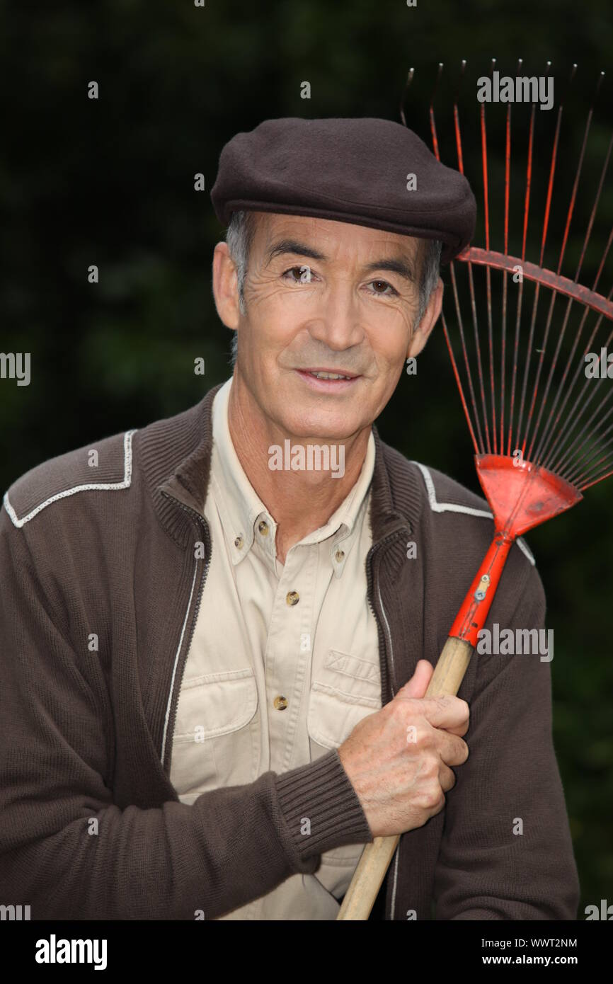 Man with rake Stock Photo - Alamy