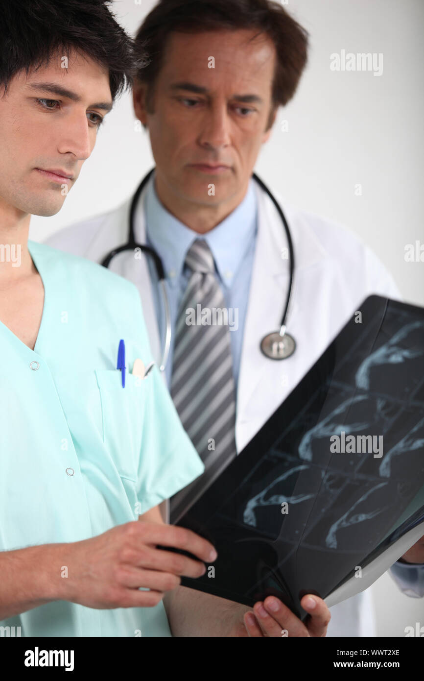 Hospital doctors checking an x-ray Stock Photo - Alamy