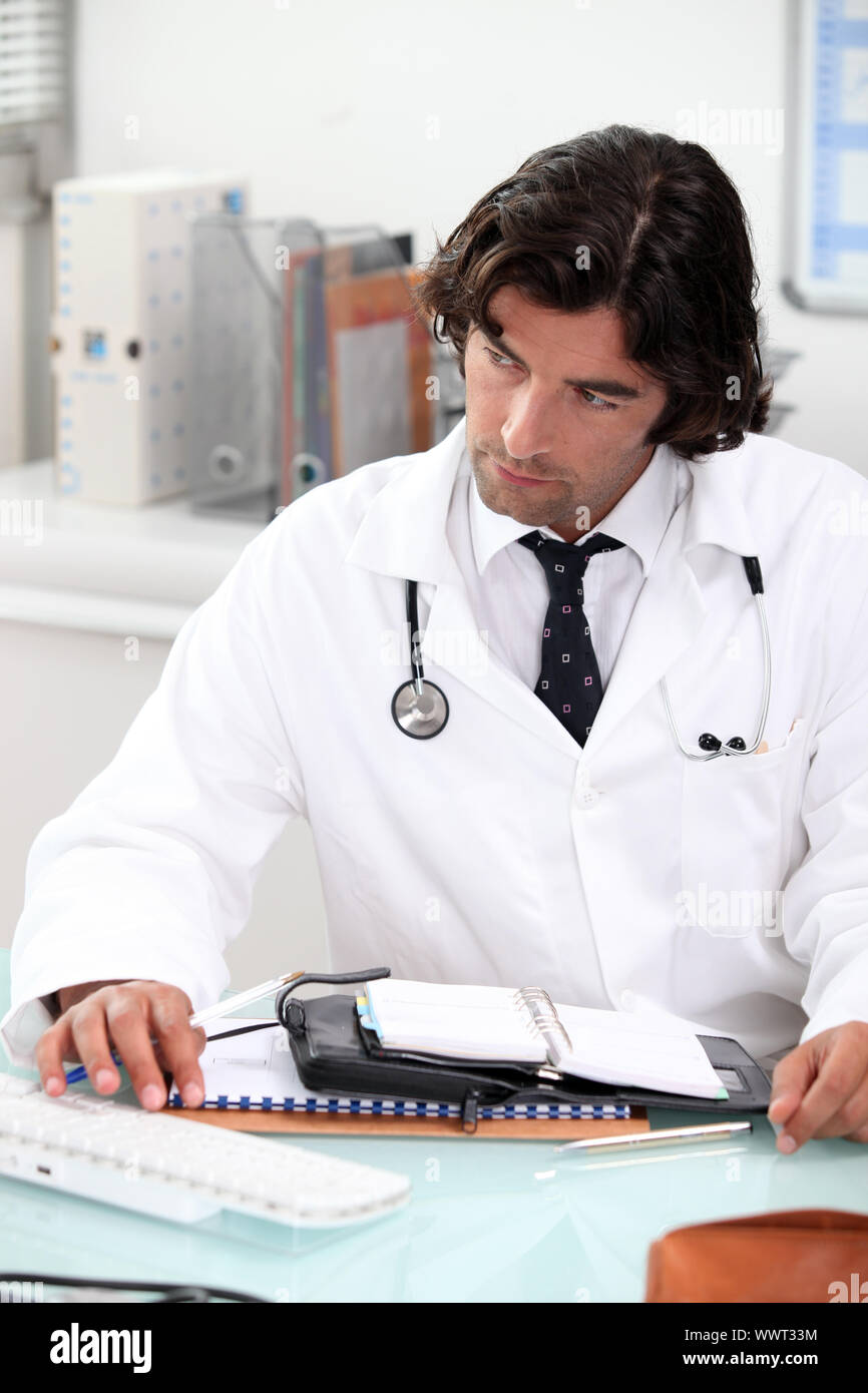 portrait of a doctor at desk Stock Photo - Alamy