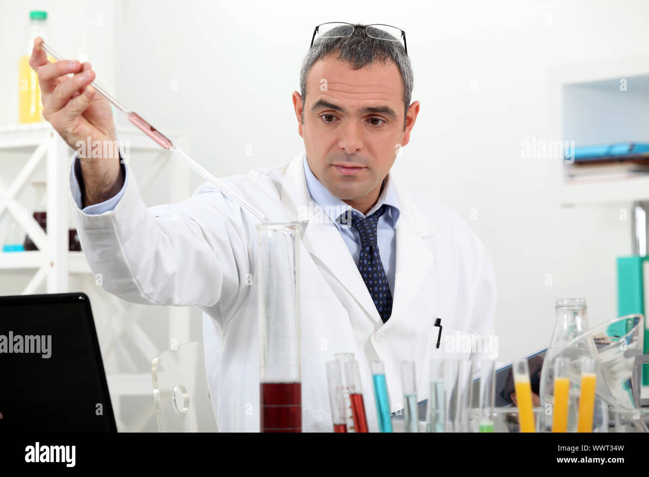 Man performing a chemistry experiment Stock Photo - Alamy