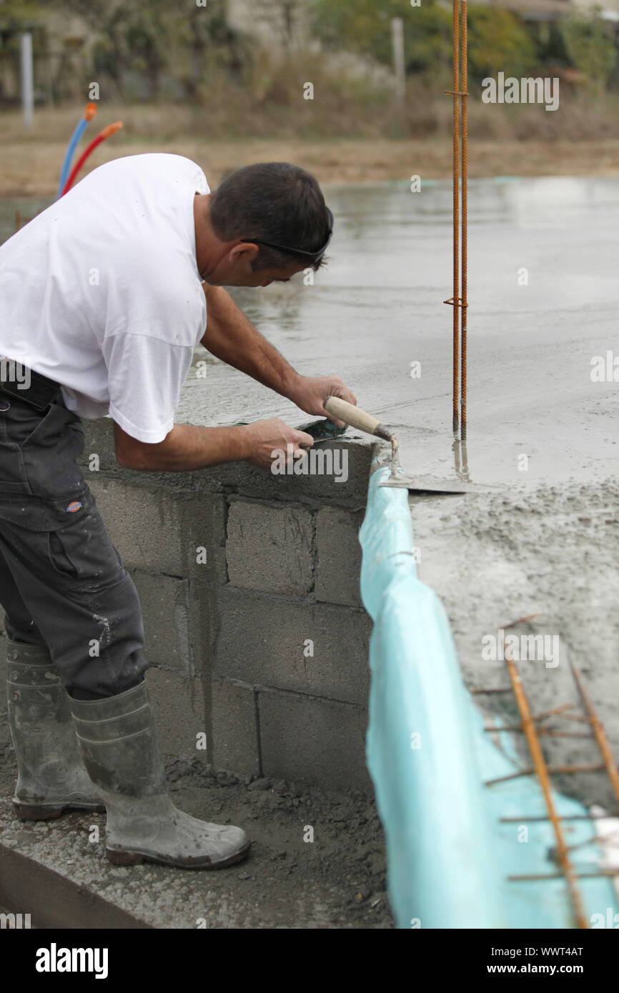Builder laying foundations Stock Photo - Alamy