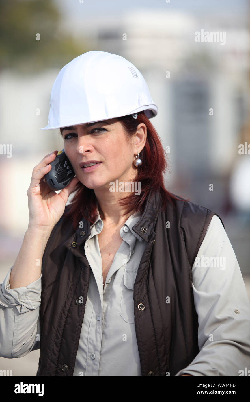 Female foreman using radio to communicate Stock Photo - Alamy