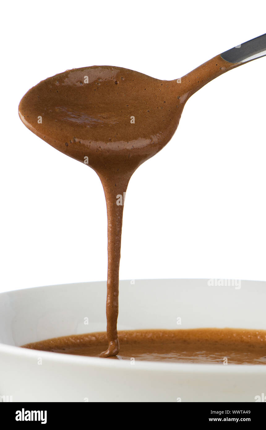 Chocolate dripping from spoon on white background Stock Photo - Alamy