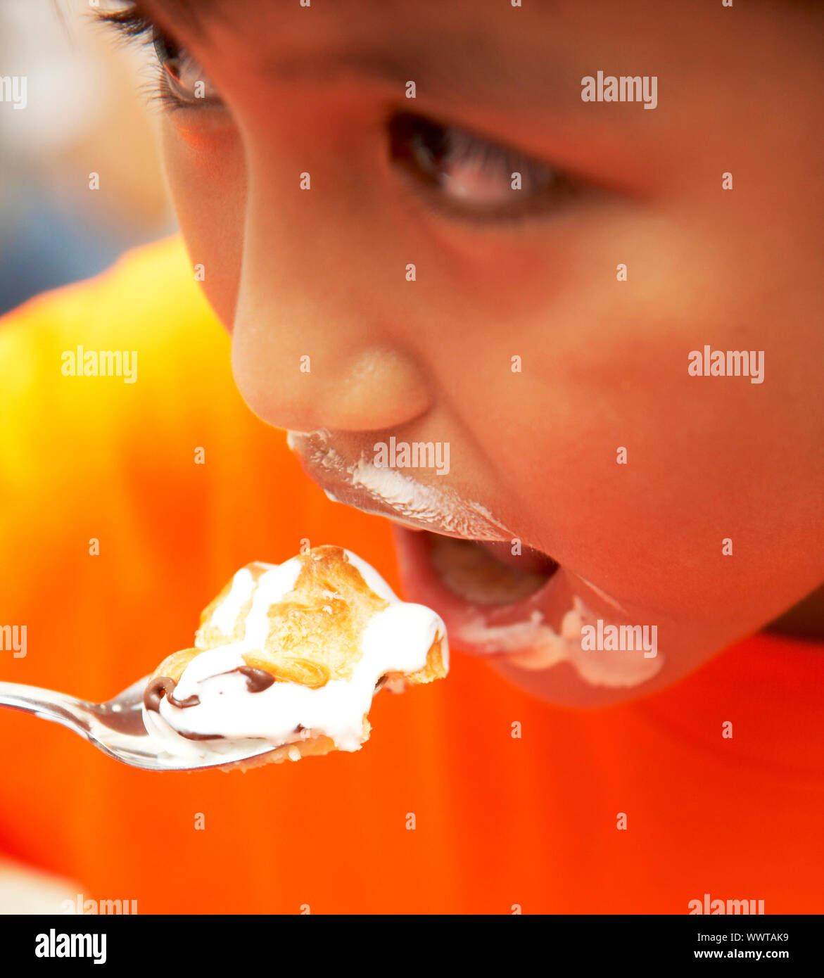 Close Up Of A Kid Eating Dessert And Getting It On His Face Stock Photo ...