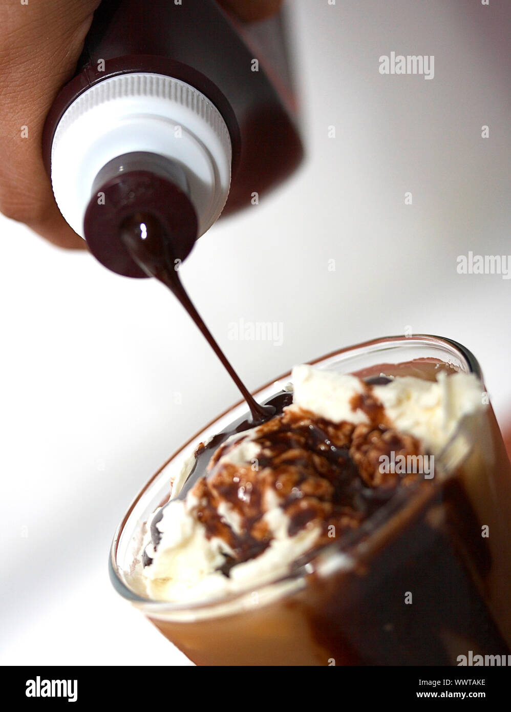 Adding Chocolate Syrup And Cream To An Ice Shake Stock Photo - Alamy