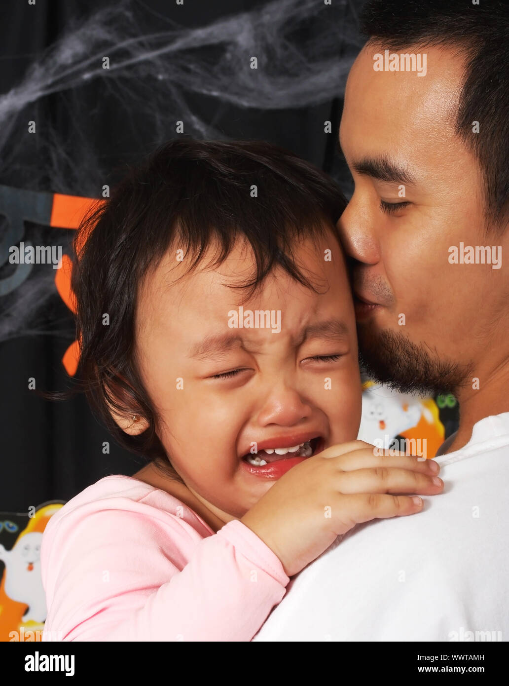 Father Cuddling And Comforting His Crying Child Stock Photo - Alamy