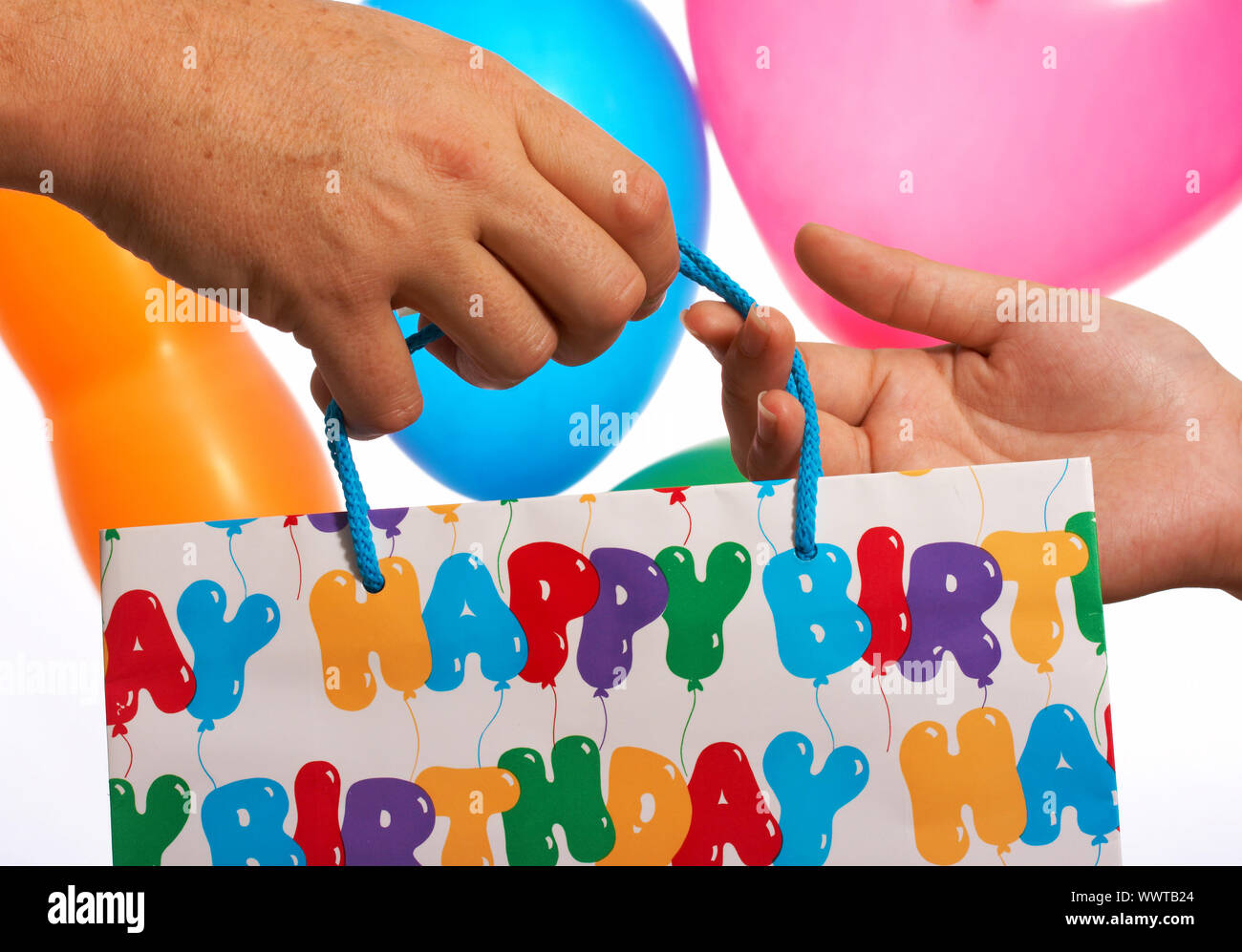 Giving A Birthday Gift At A Party Stock Photo - Alamy