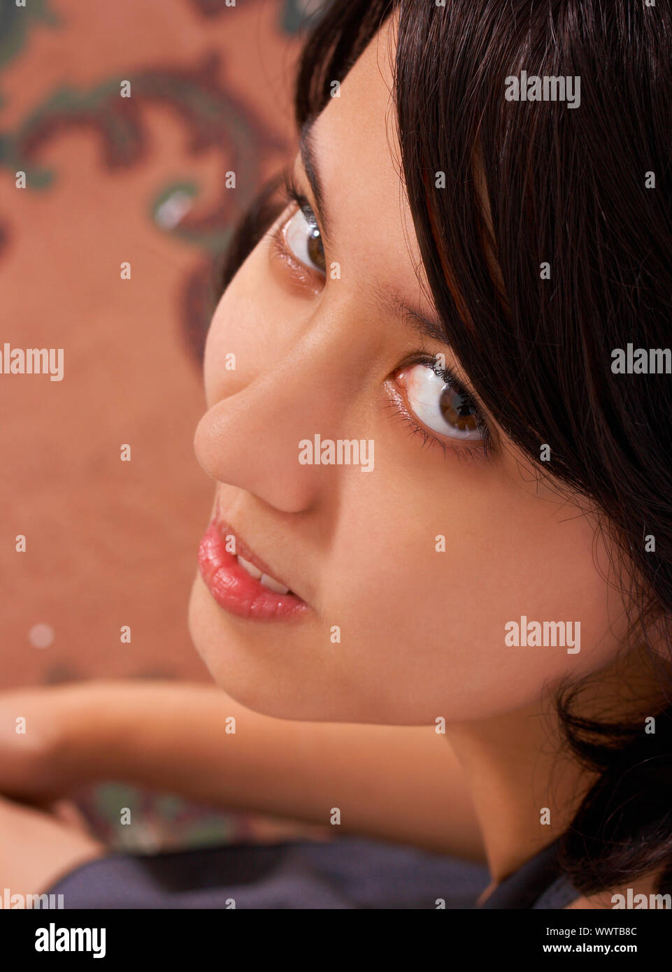 Beautiful Girl Looking Serious And Looking Up At The Camera Stock Photo ...