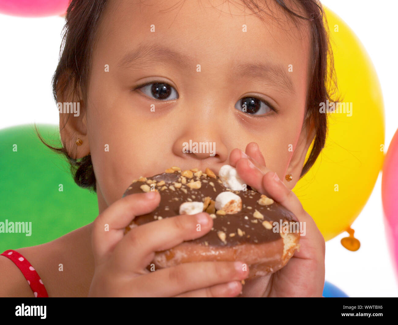 Kid Eating A Sweet Sugary Donut At The Party Stock Photo - Alamy