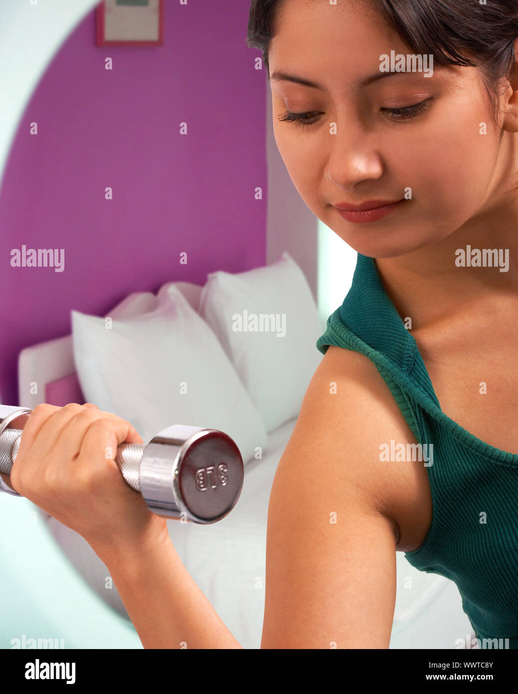 Woman Using Dumbbell To Improve Her Muscles Stock Photo - Alamy
