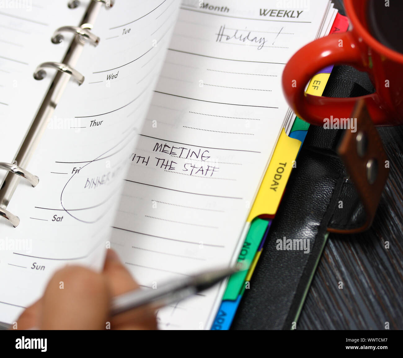 Using A Personal Organizer To Organize The Events For The Next Week ...