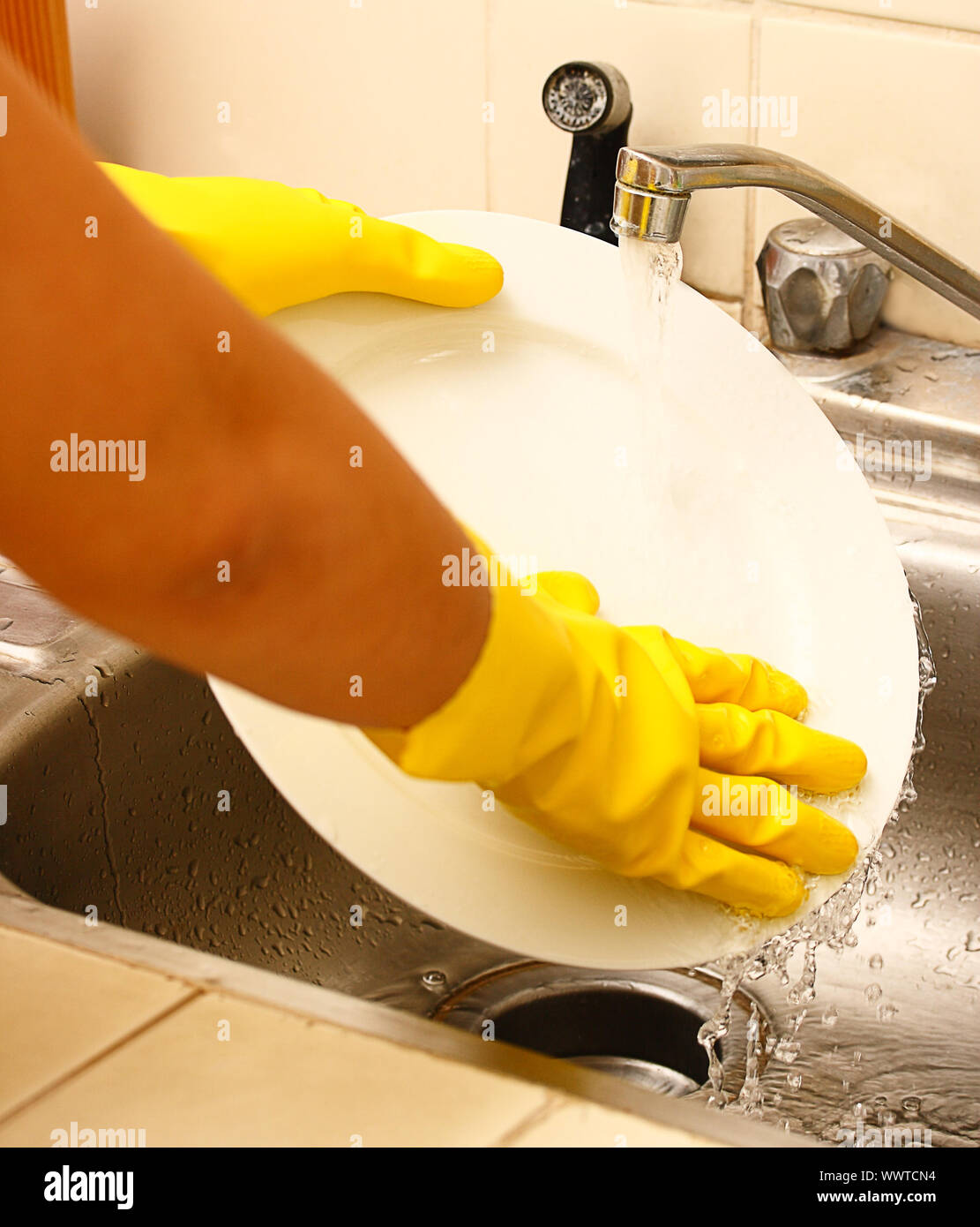 Washing Plates As Part Of The Daily Chores Stock Photo - Alamy