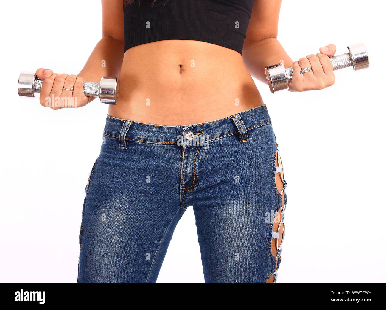 Slim Girl Improving Her Figure Using Dumbbells Stock Photo - Alamy