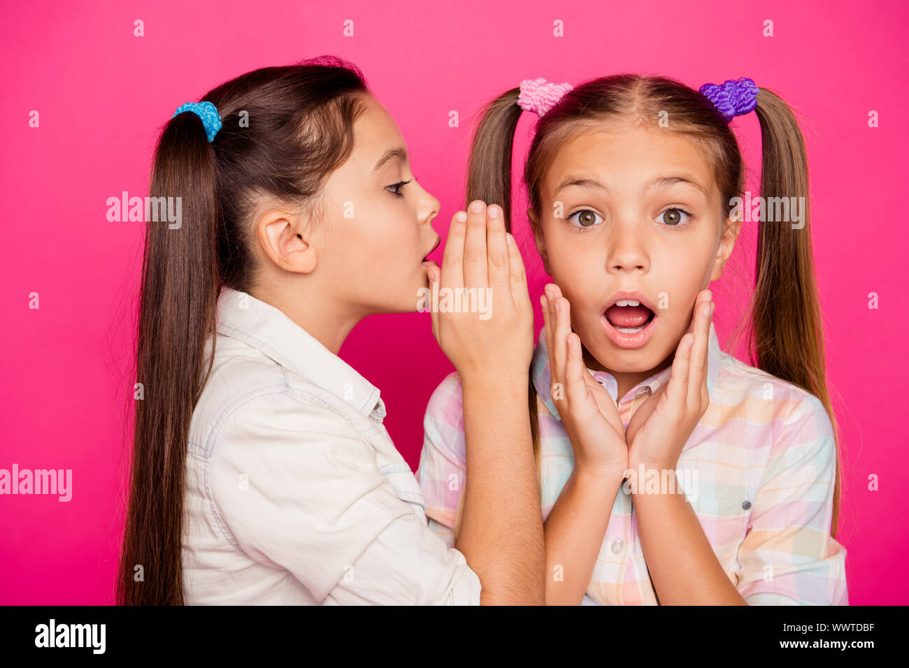 Close up photo two small little age girls tell talk speak in ear ...