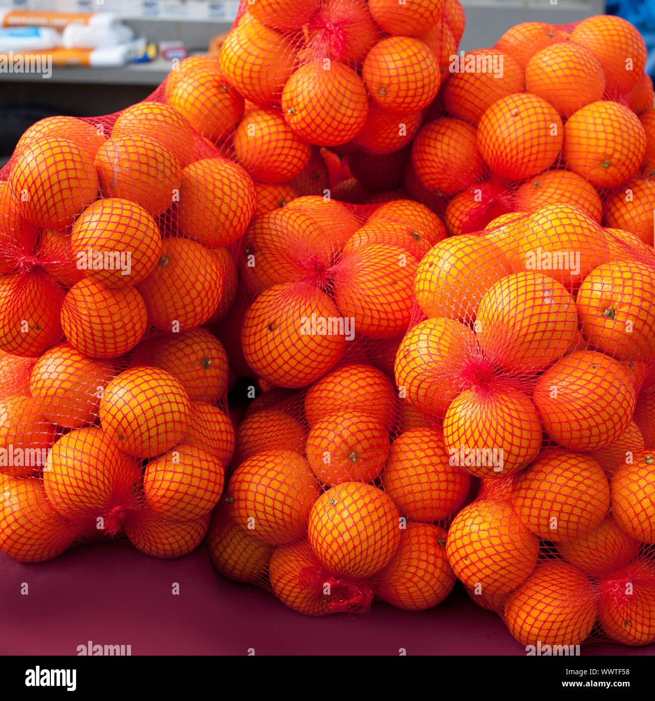 oranges fruit on market in red net bags Stock Photo - Alamy