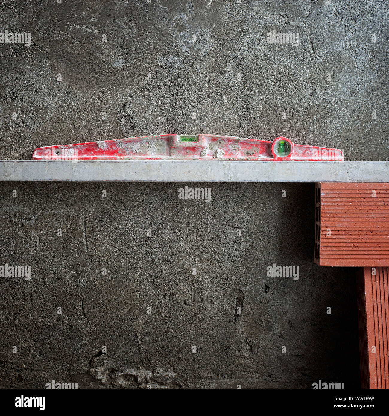 Brickwall construction cement plaster rulers hi-res stock photography ...