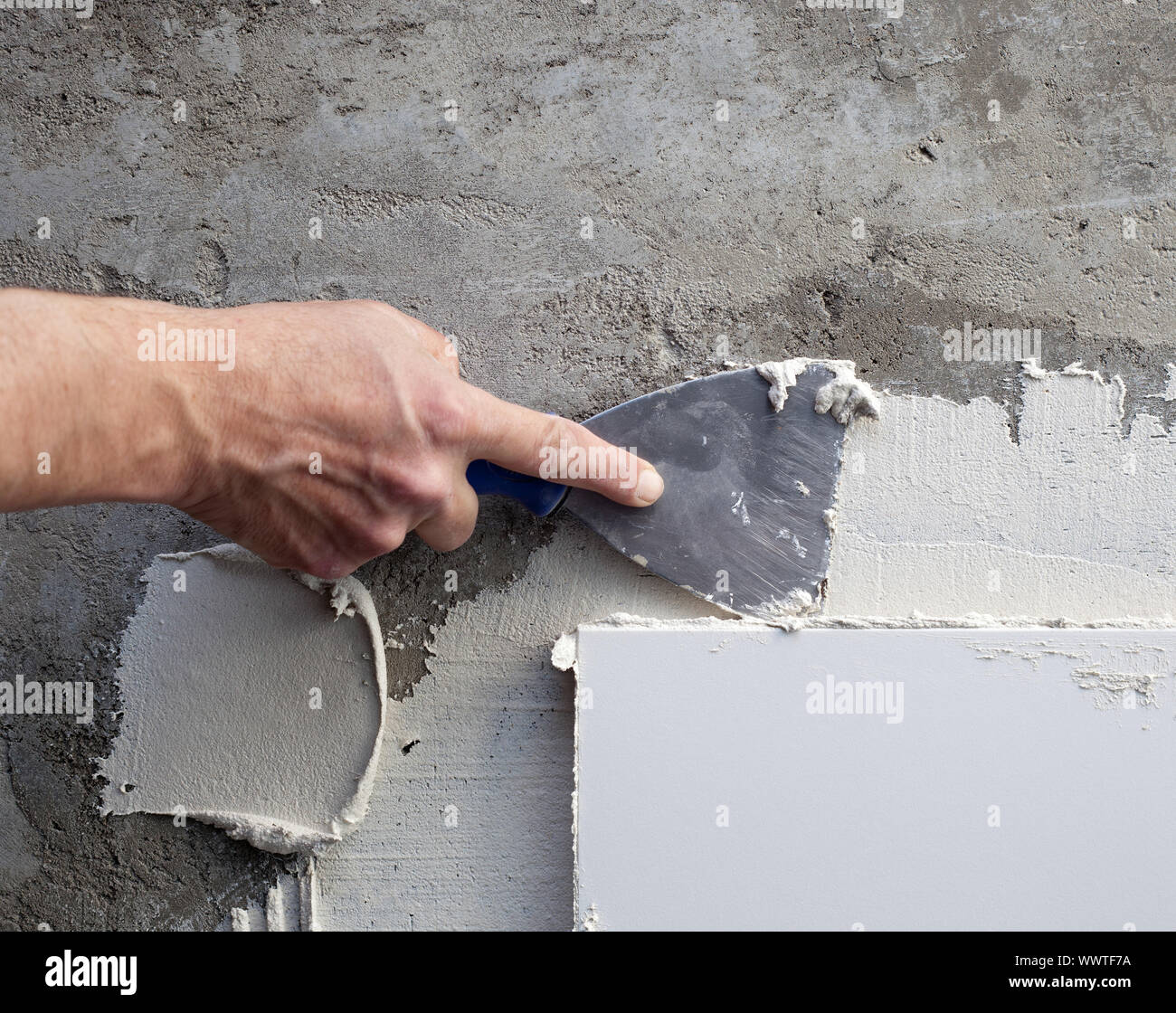 construction spatula trowel in tile work with white mortar Stock Photo ...