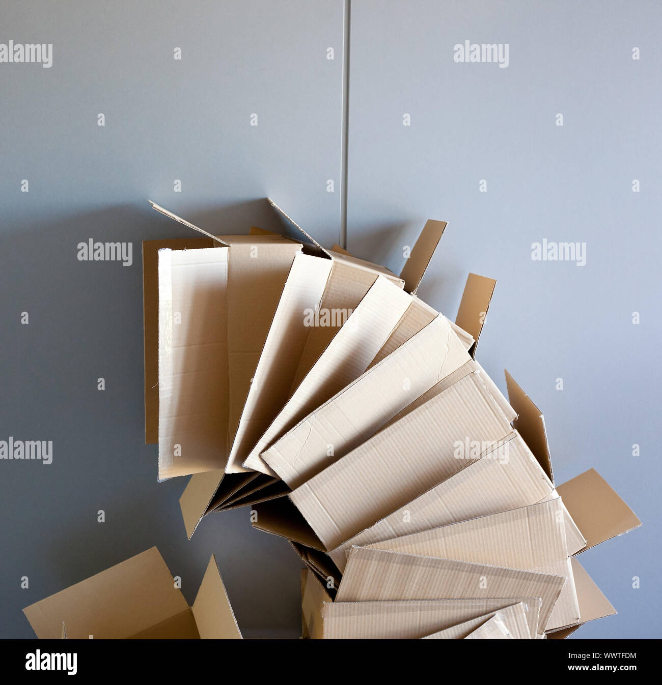 carton open boxes stacked on curved circle shape on gray wall Stock ...