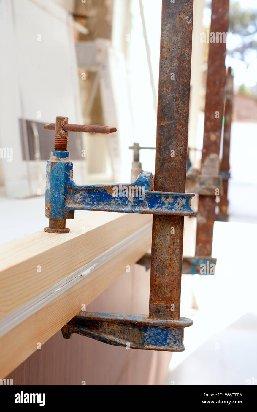 Carpenter screw clamp tools pressing wood slats ang white glue Stock ...