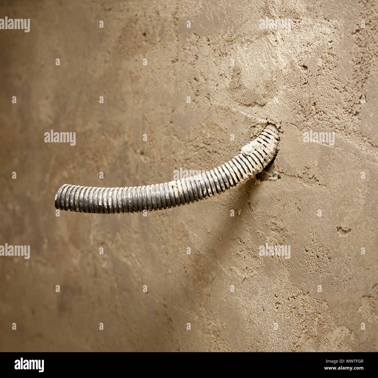 electrical coil conduit pipe on box embedded in the cement mortar wall ...