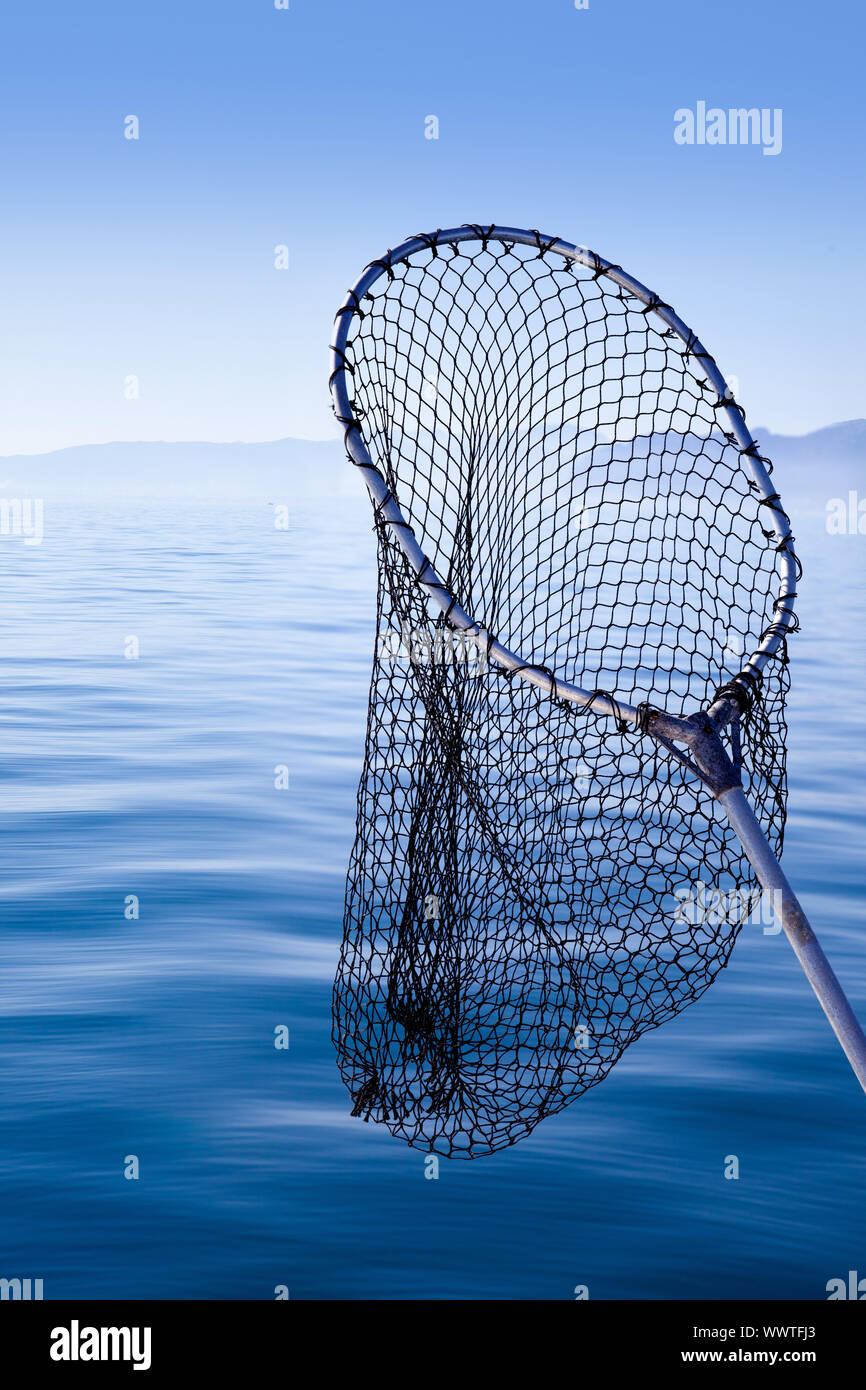 fishing landing net in blue sea at Mediterranean Stock Photo - Alamy