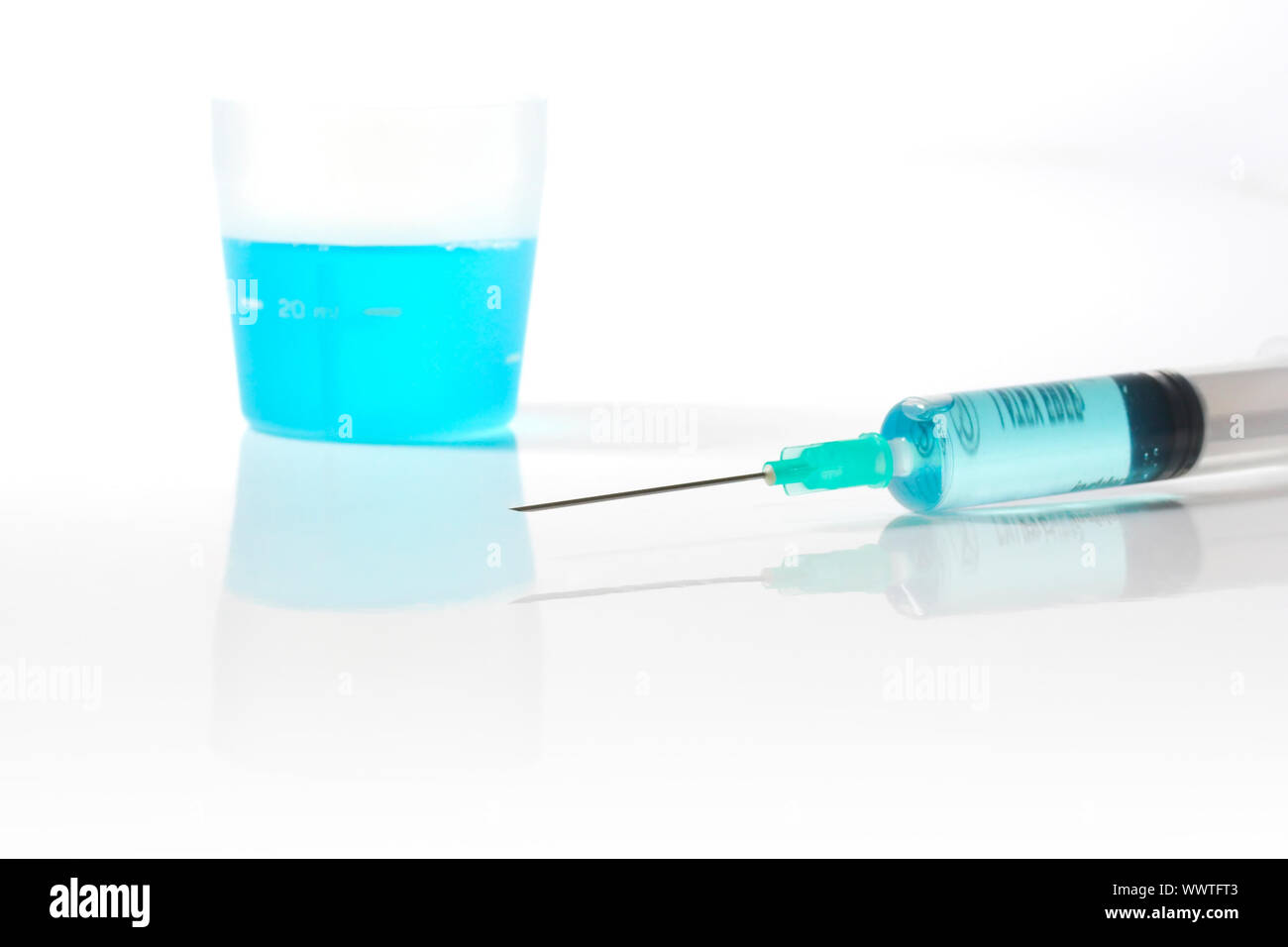 Syringe with blue liquid Stock Photo - Alamy