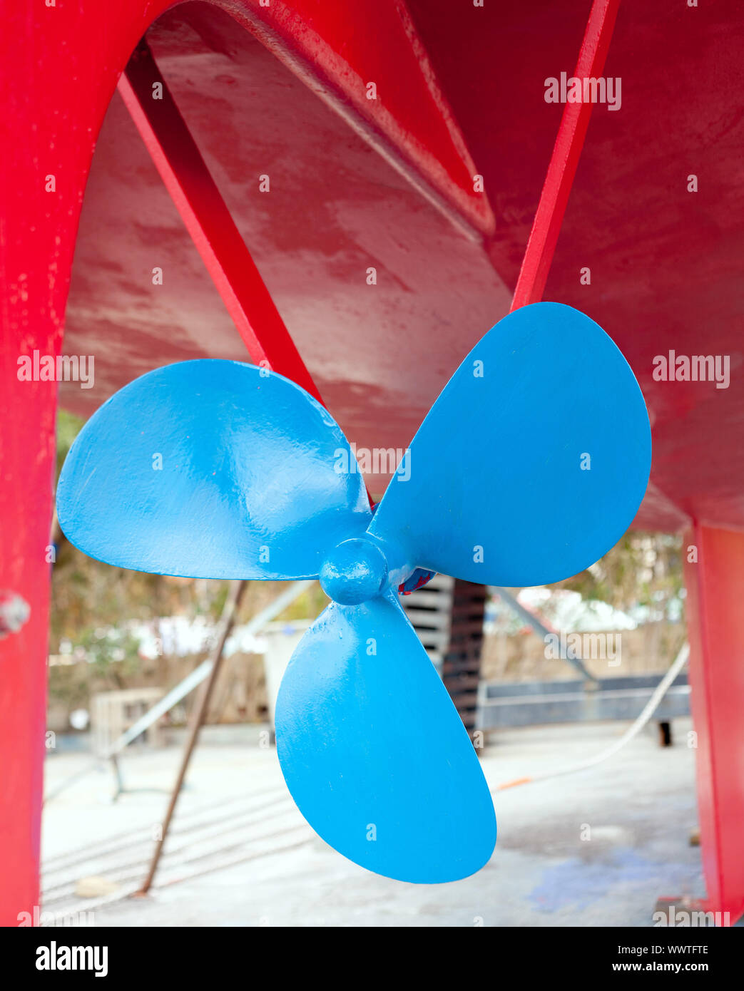 blue sailboat propeller in a red painted hull Stock Photo - Alamy