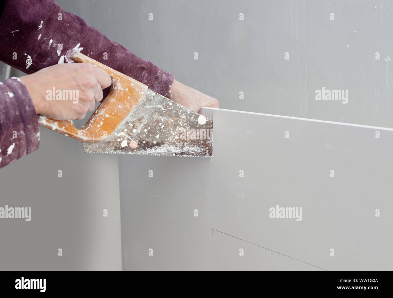 cutting plasterboard plaster hand with grunge dirty saw Stock Photo - Alamy