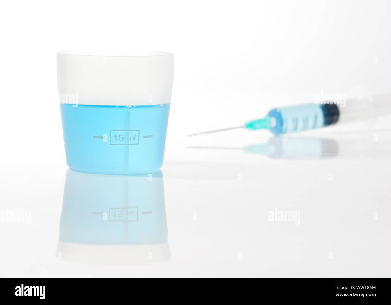 Syringe with blue liquid Stock Photo - Alamy