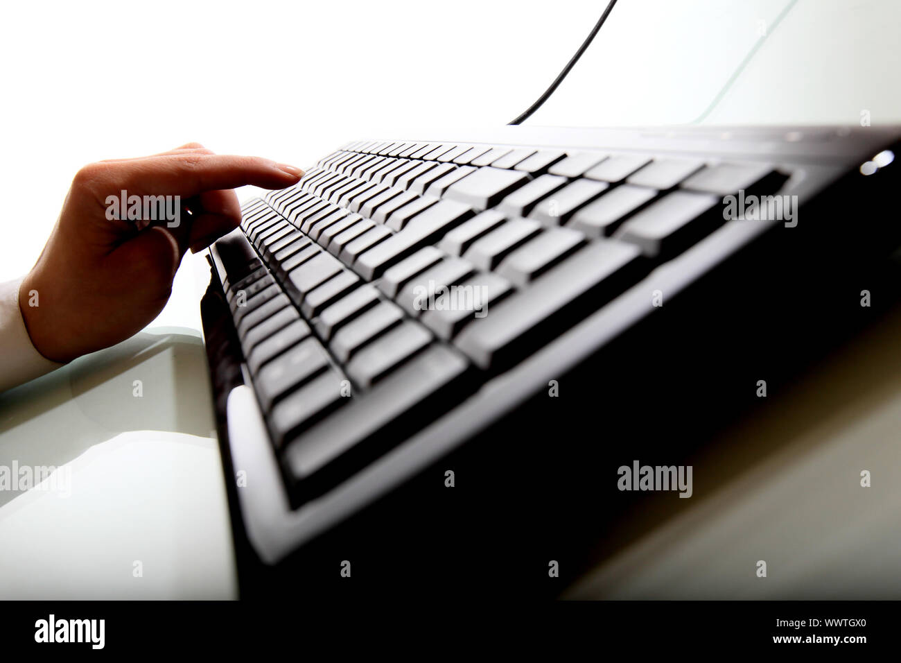 hand press a key on keyboard Stock Photo - Alamy