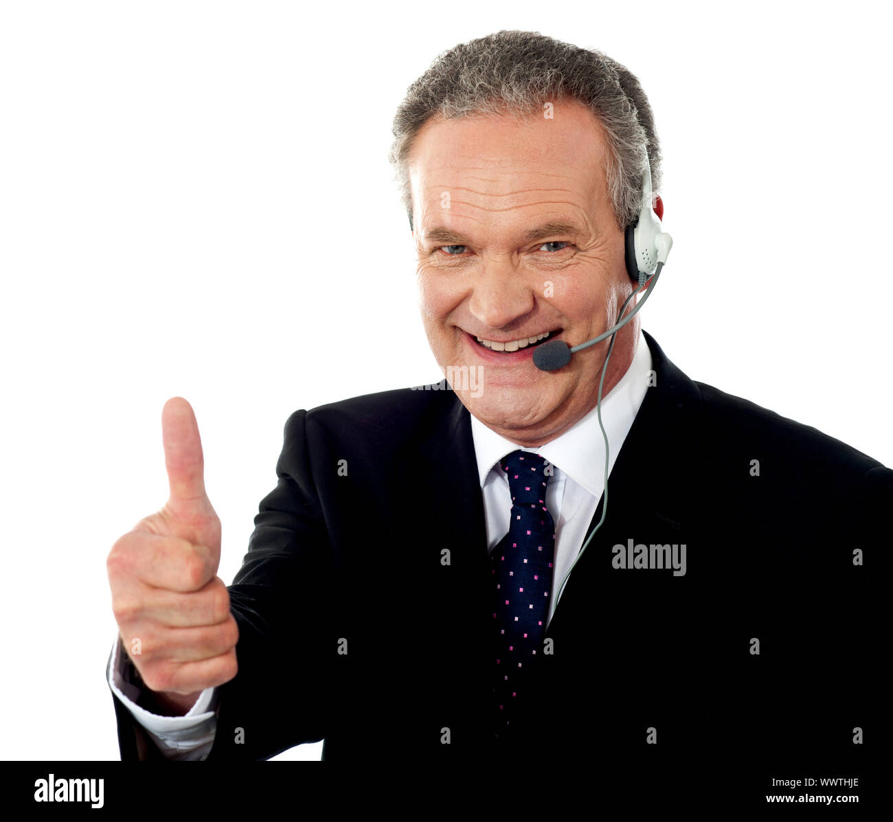 Call centre executive smiling with thumbs-up gesture isolated over whte ...