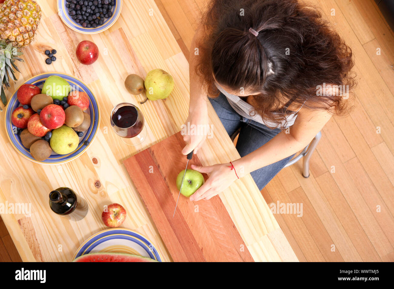 Woman cutting fresh kiwi hi-res stock photography and images - Alamy