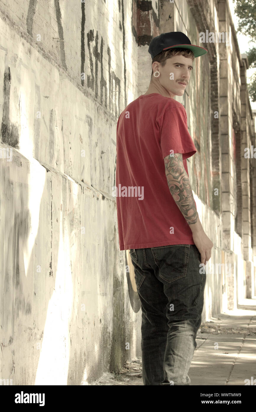 Rapper leaning on a Wall Stock Photo - Alamy