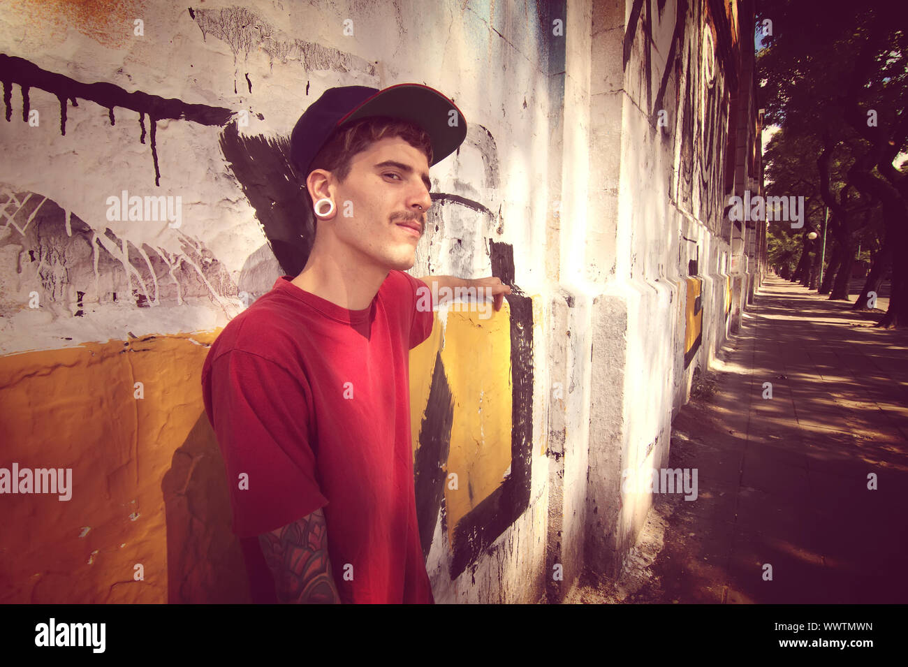 Rapper leaning on a Wall Stock Photo - Alamy