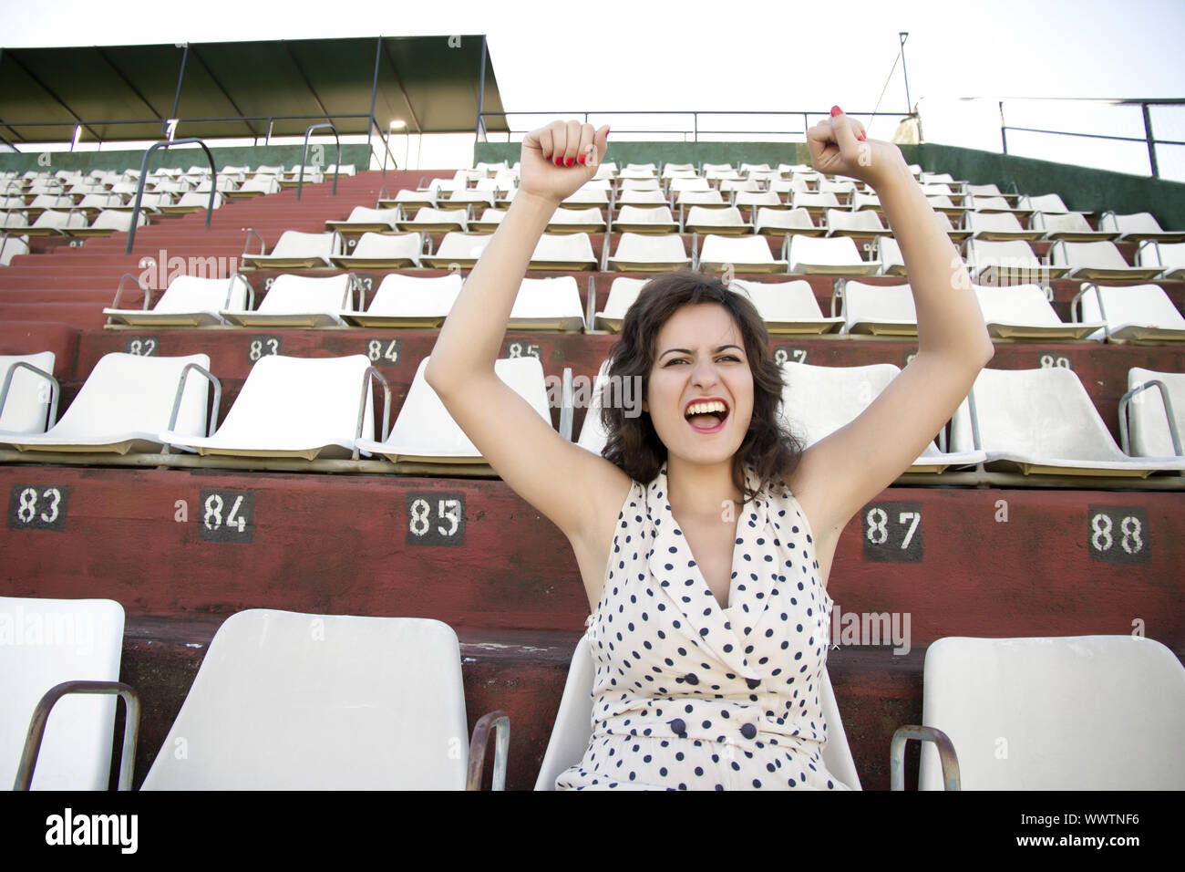 Retro cheering girl in stadium Stock Photo - Alamy
