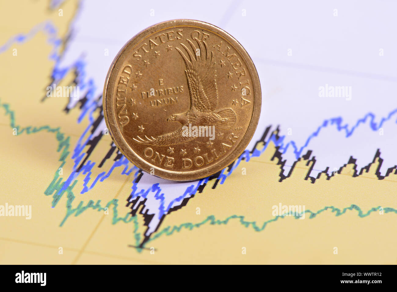 Dollar coin and currency with currency chart Stock Photo - Alamy