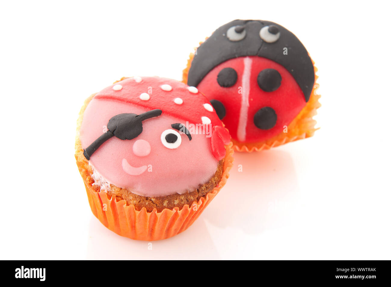 cupcakes with pirate and ladybug isolated over white background Stock ...