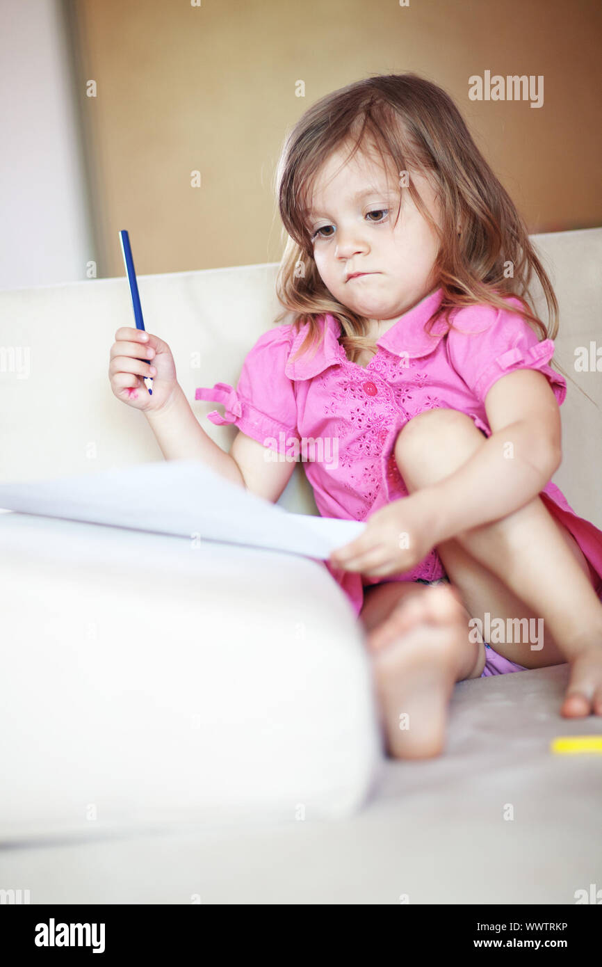 Child drawing alone at home Stock Photo - Alamy
