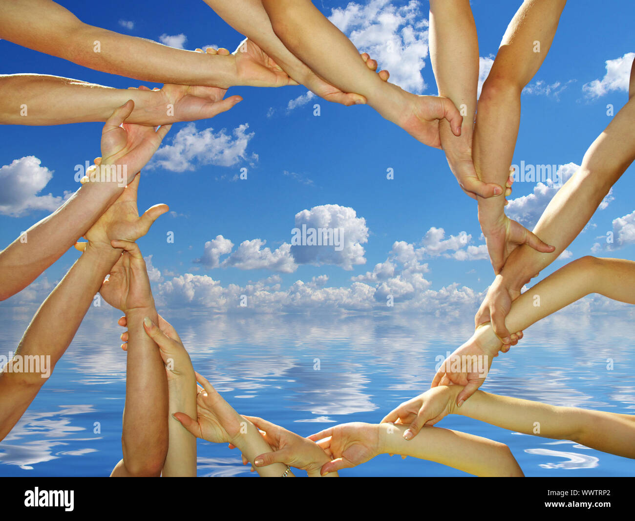Ring of hands on blue Stock Photo - Alamy
