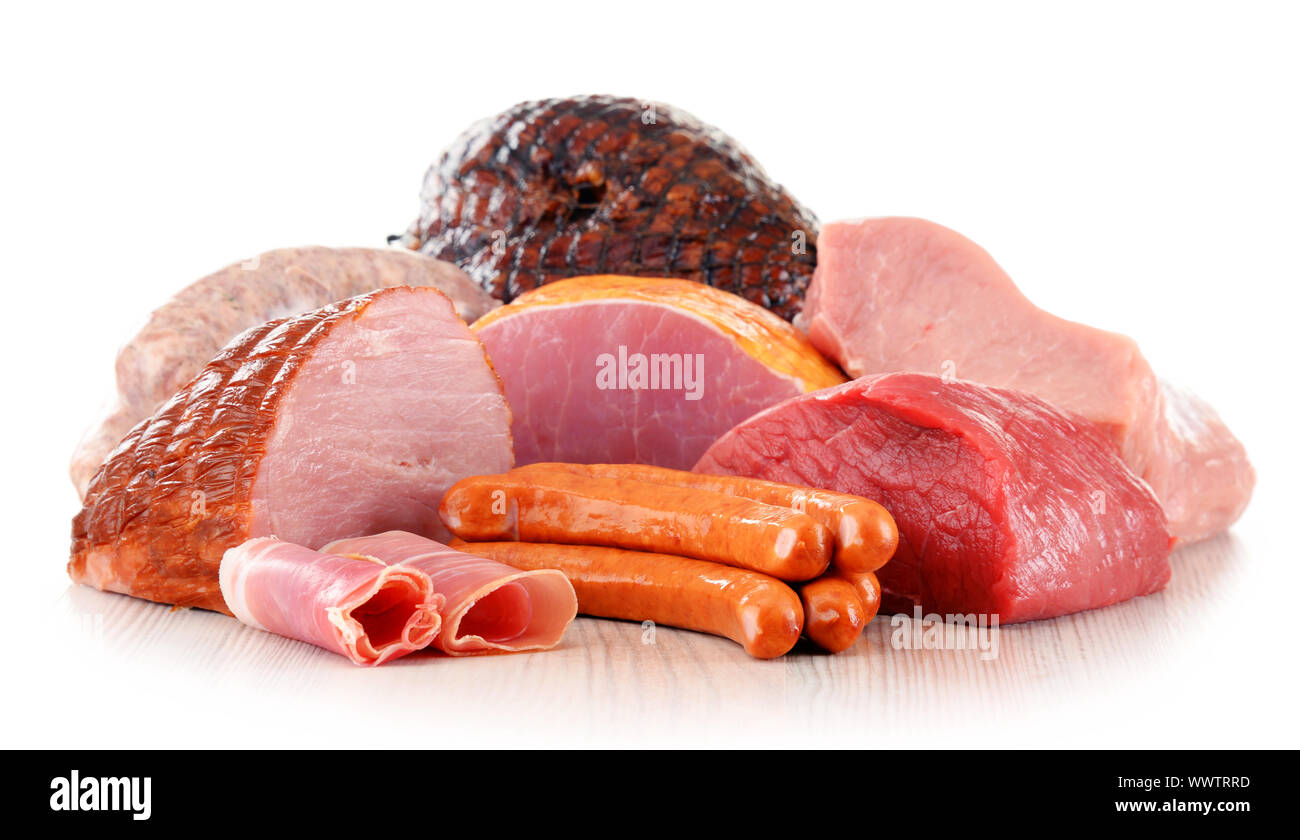 Assorted meat products including ham and sausages isolated on white ...