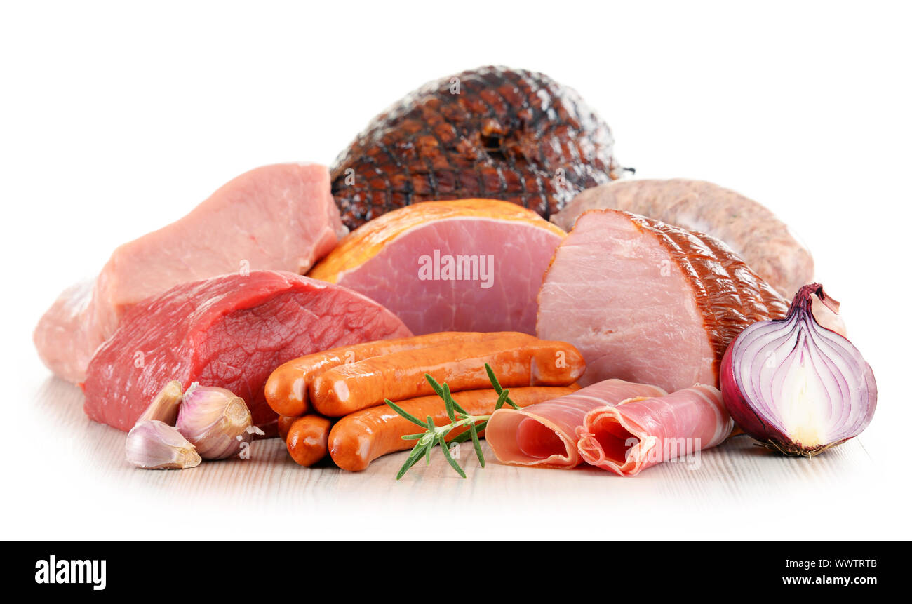 Assorted meat products including ham and sausages isolated on white ...